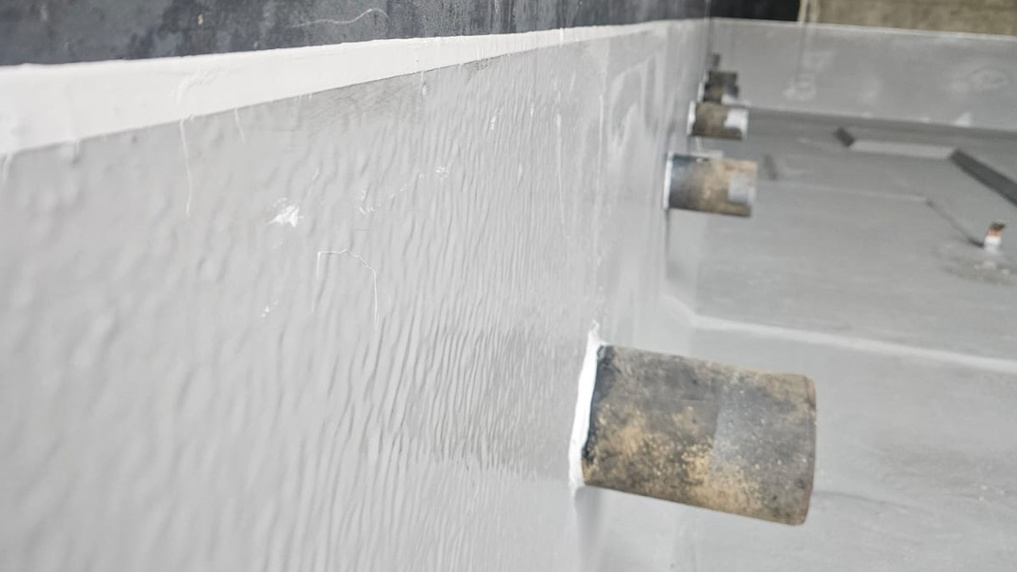 Applying Polyurea Coating to Line a Concrete Bund in Preparation for ...